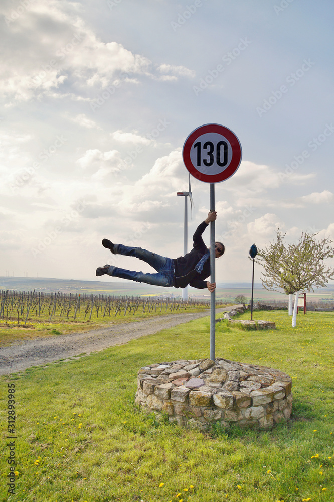 130 kmph or mph driving speed limit sign. strong pole dancer man in ...