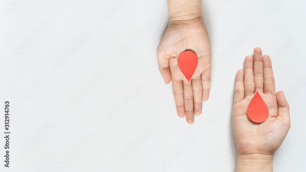 Blood donation - Human hand giving blood drop symbol to a hand on white ...