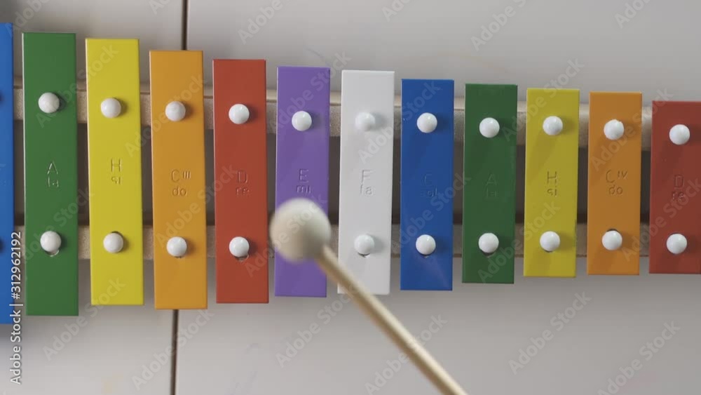 Child playing with a colorful xylophone and learning music. Child ...