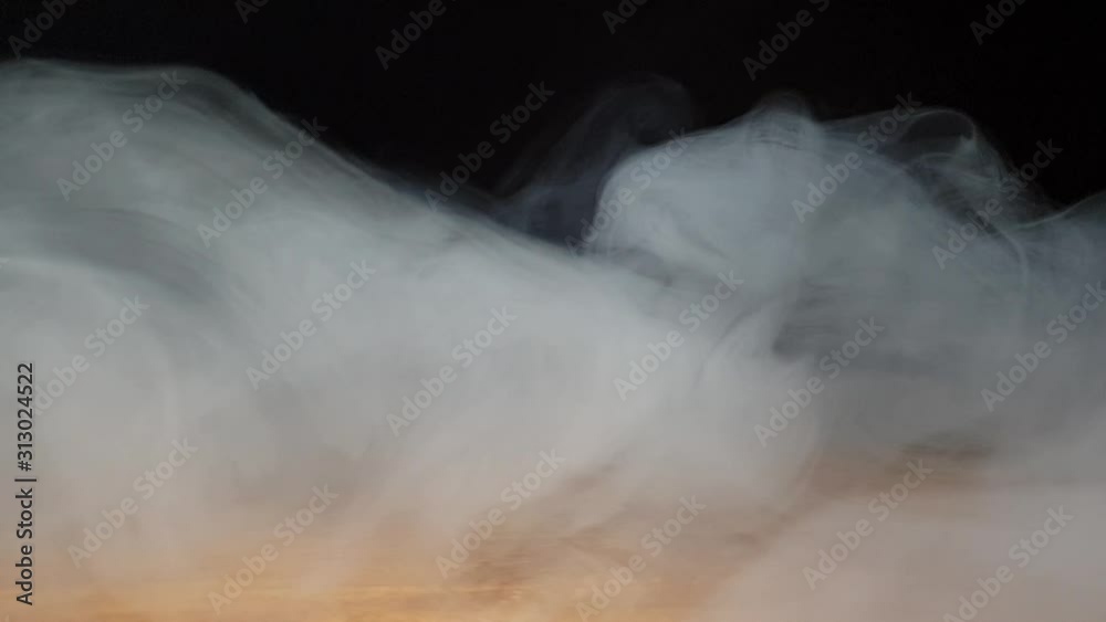 Ominous and scary white smoke fog rolling over an old oak table with a ...