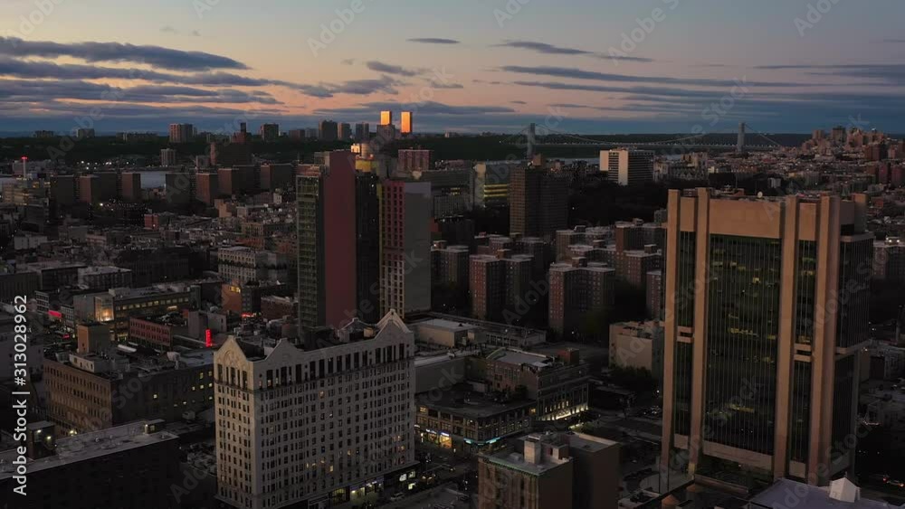Aerial slide across the Harlem neighborhood of NYC at sunset blue ...