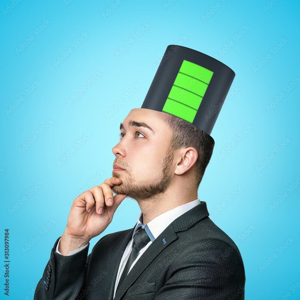 Crop image of businessman in half-turn thinking with hand at chin and ...