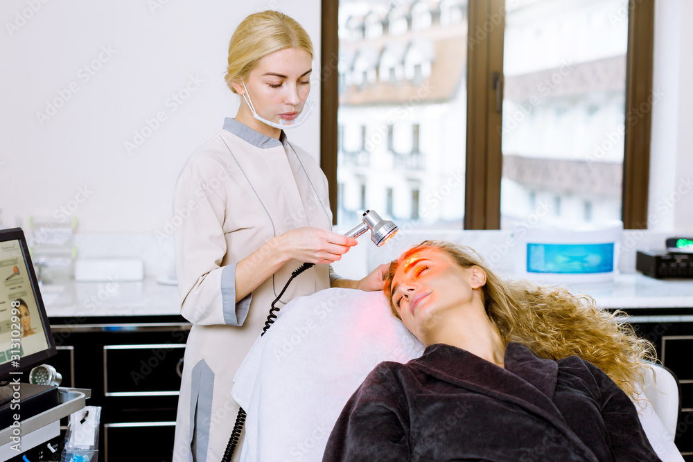 Light infrared therapy. Cosmetology face procedure. Beauty woman face ...