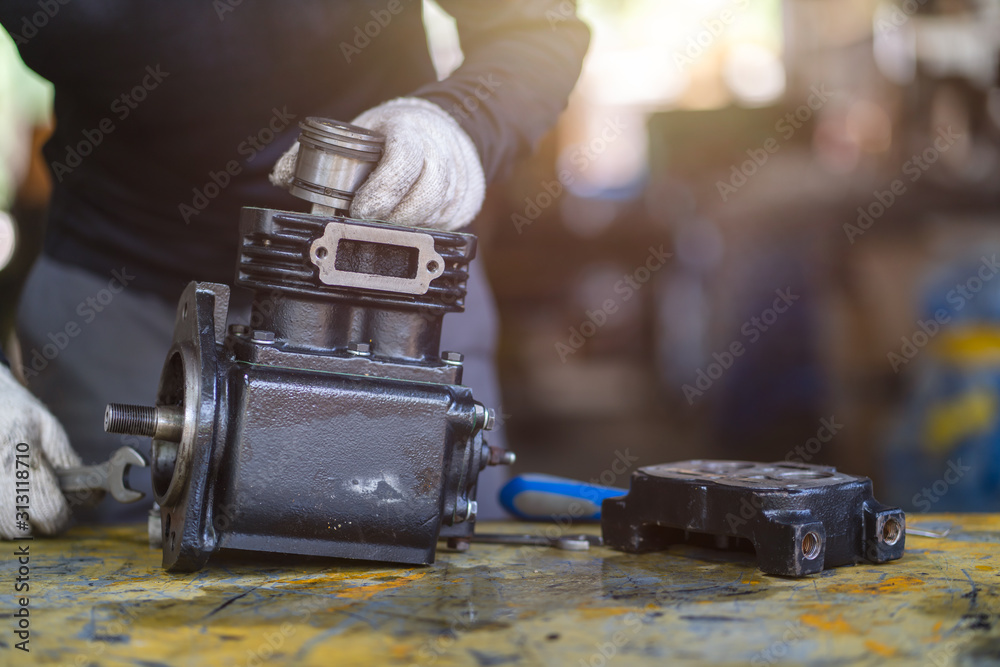 Mechanic man inspecion a piston of air compressor pump, Mechanical ...