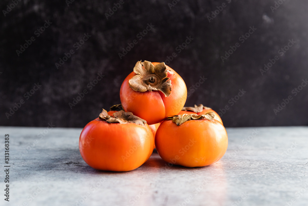Ripe Fuyu Persimmon Isolated on a Combo Light/Dark Background Stock ...