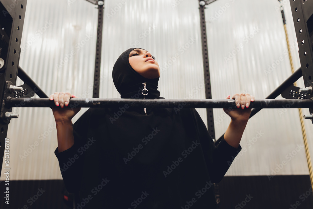 Muslim asian woman in hijab exercizing in a gym. Stock Photo | Adobe Stock