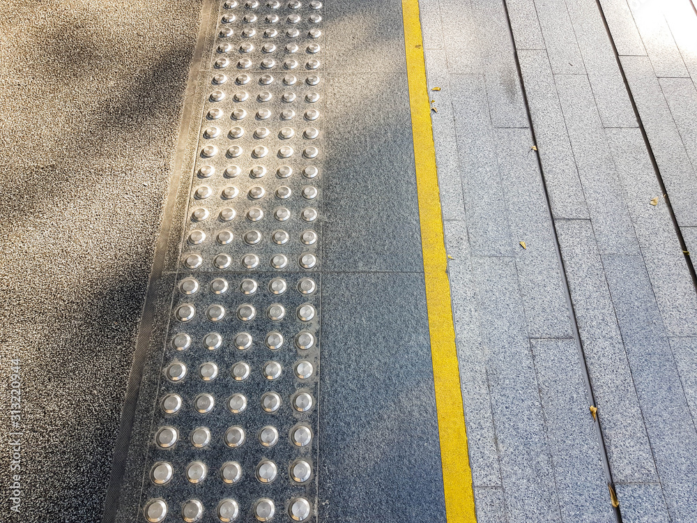 Blind Block tiles installed at the gap of concrete platform with yellow ...