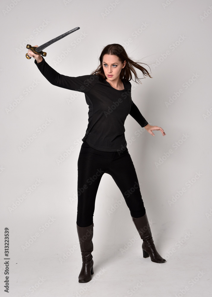 full length portrait of a pretty brunette girl wearing a black shirt ...