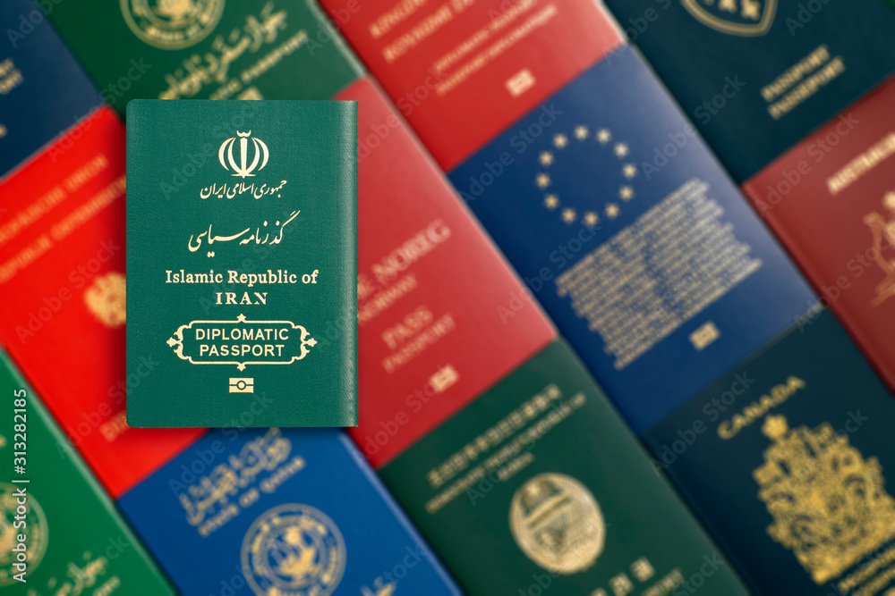 Green diplomatic pasport of Islamic Republic of Iran on a blurred ...
