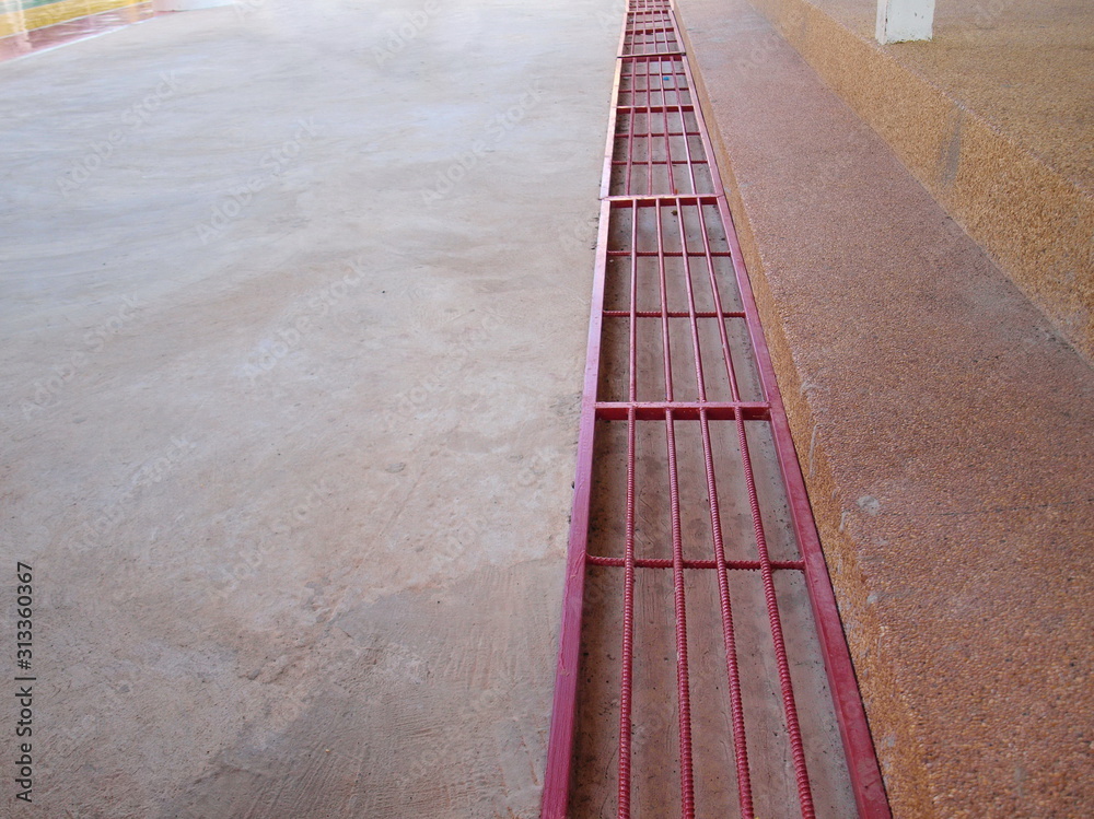 Steel grating on drainage channels Red metal grating on a small ...