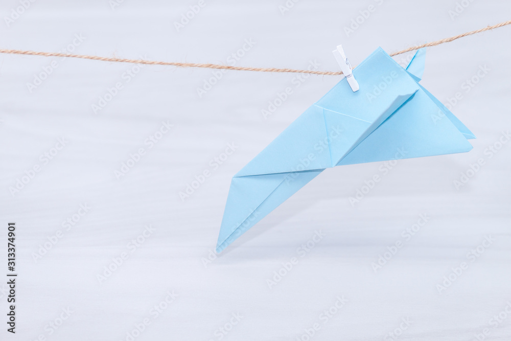 Fear of flying, plane crash or aerophobia concept. Blue paper plane ...