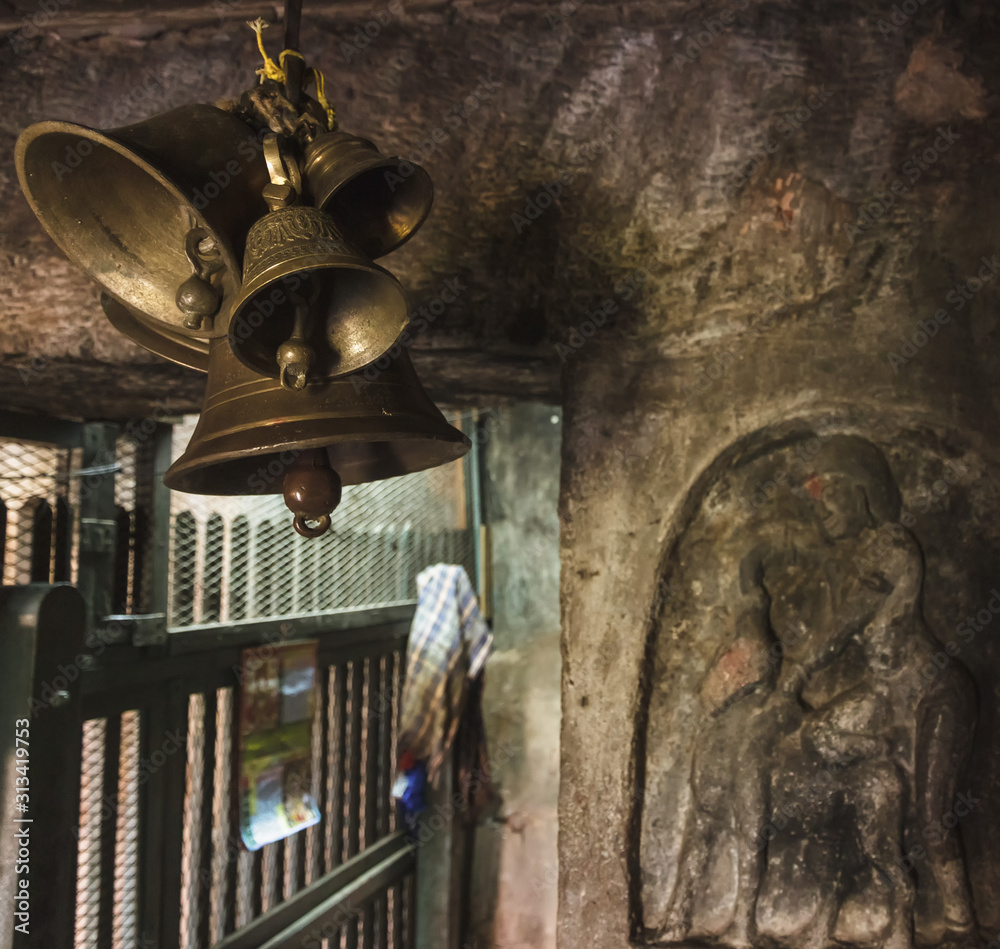 Temple bells inside a dark hall inside the ancient 7th century ...