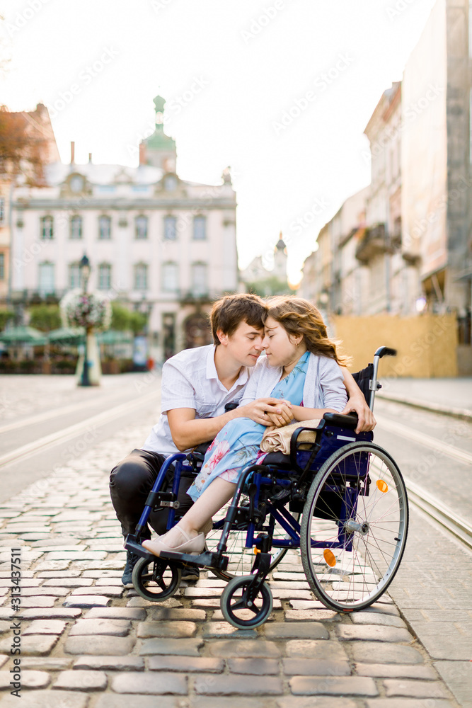 Couple in love in old city center. Pretty young girl with disease on a ...