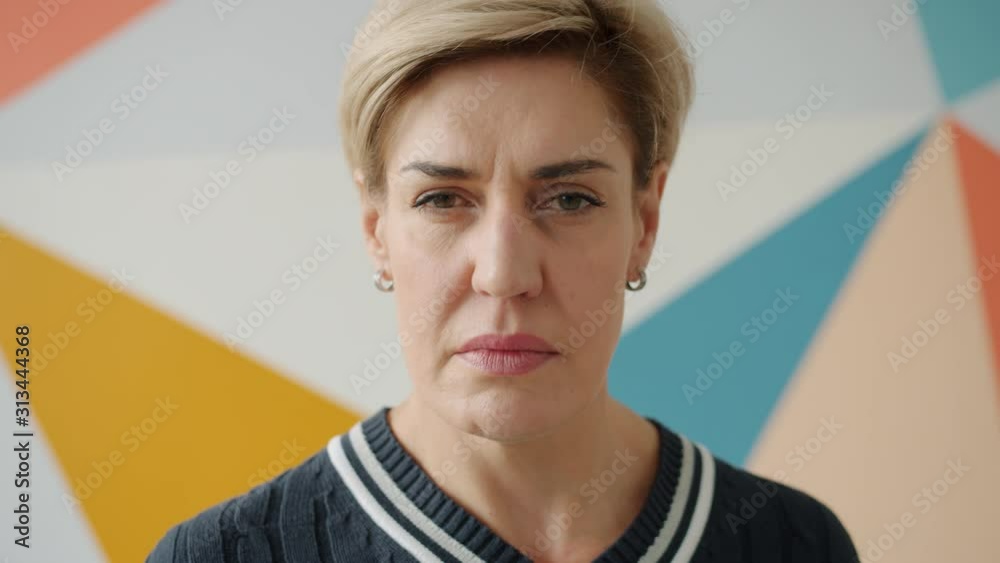 Slow motion portrait of angry woman looking at camera with indignation ...