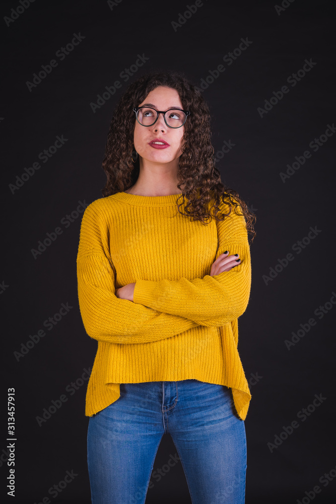 Young girl model posing with yellow t-shirt and blue pants in black ...