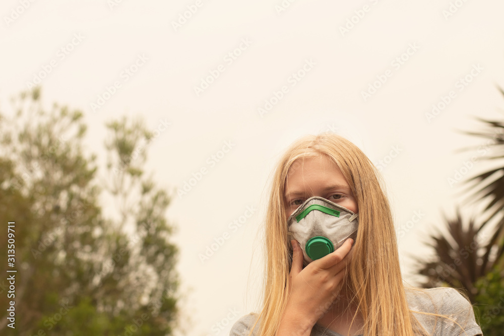Australian bushfire: blond girl wearing P2 N95 protection respiratory ...