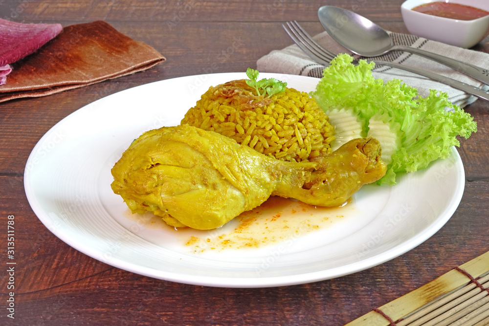 Foto de Biryani rice with chicken drumstick. Biryani, also known as ...