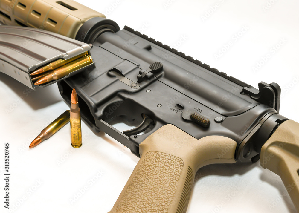 An multi colored AR 15 rifle with a rifle magazine loaded with 223 ...
