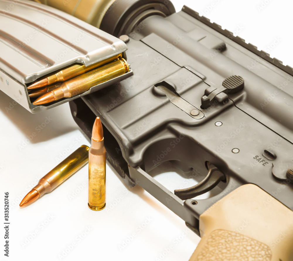 An multi colored AR 15 rifle with a rifle magazine loaded with 223 ...