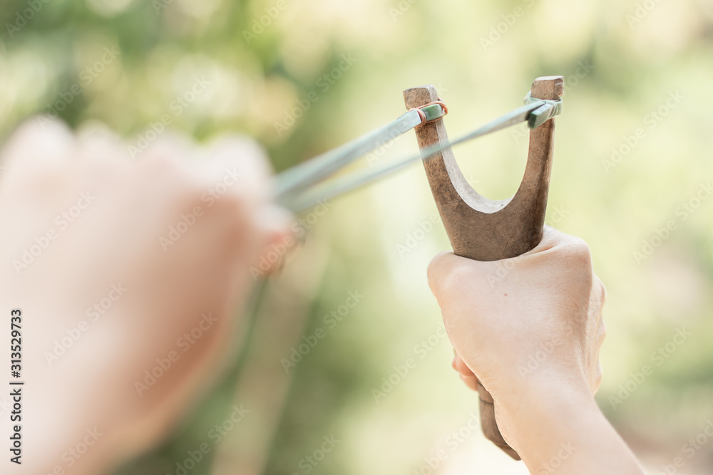 Human pulling slingshot and ready to fire. Stock Photo | Adobe Stock