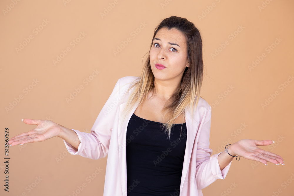 Pretty young woman shrugging shoulders. Young lady looking uncertain ...