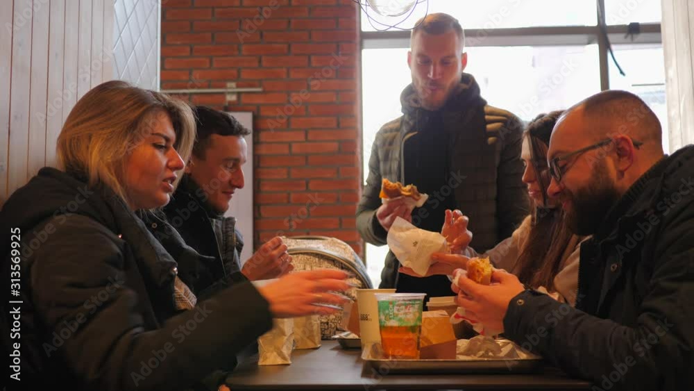Hang out guys friends eat in fast food restaurant hamburgers french ...