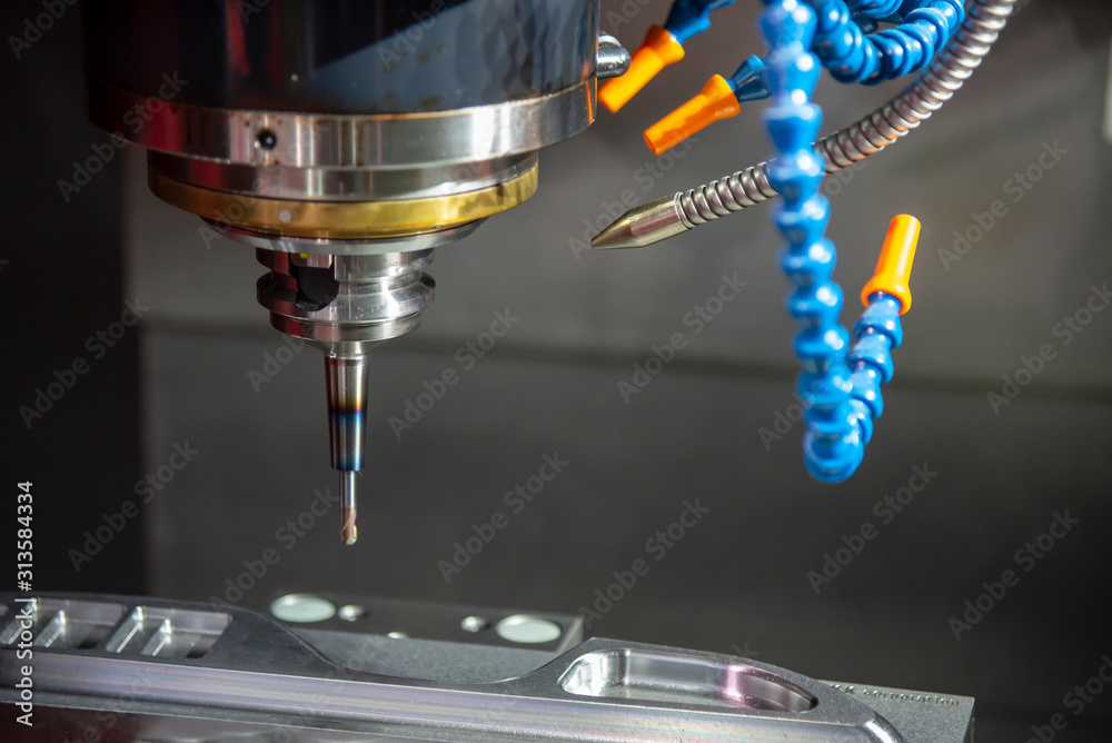 The CNC milling machine finishing cut the injection mold parts with the ...