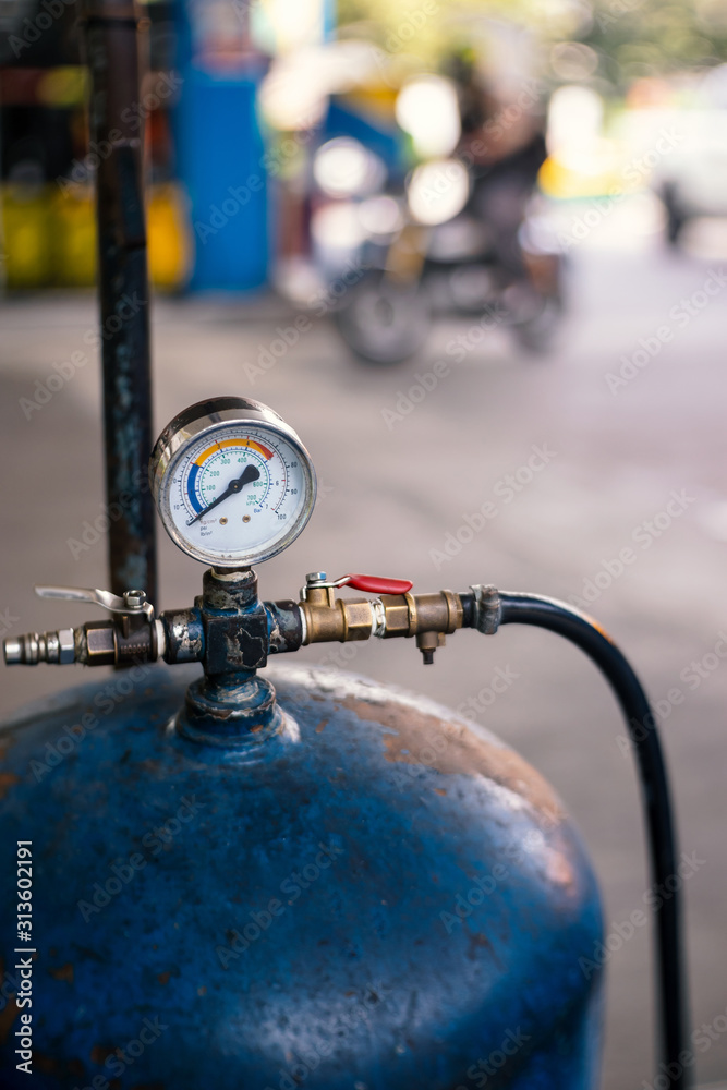 detail of tire Inflator in gas station, old air pressure tank with ...