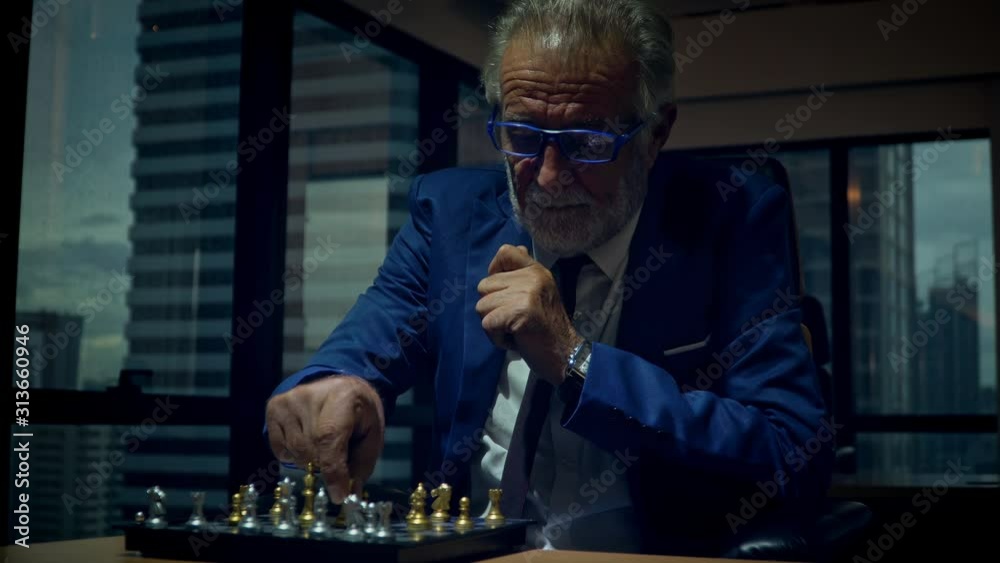 4K Senior business man CEO in blue working suit thinking playing golden ...