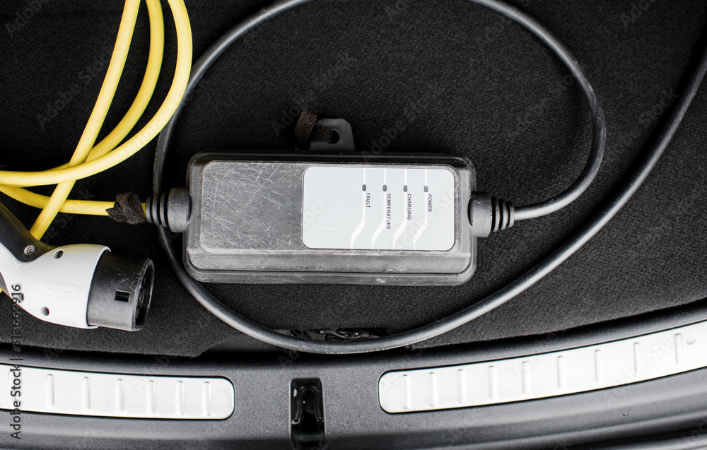 electric car lead in the trunk of a car Stock Photo | Adobe Stock