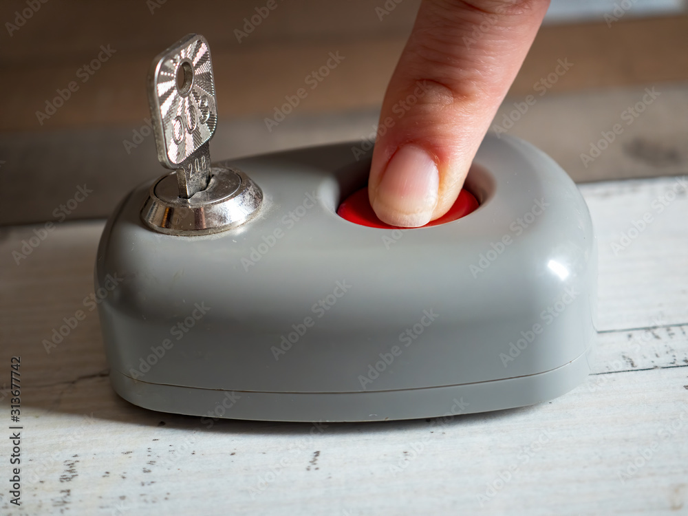 woman presses red alarm button. Close-up of a finger on a button. The ...