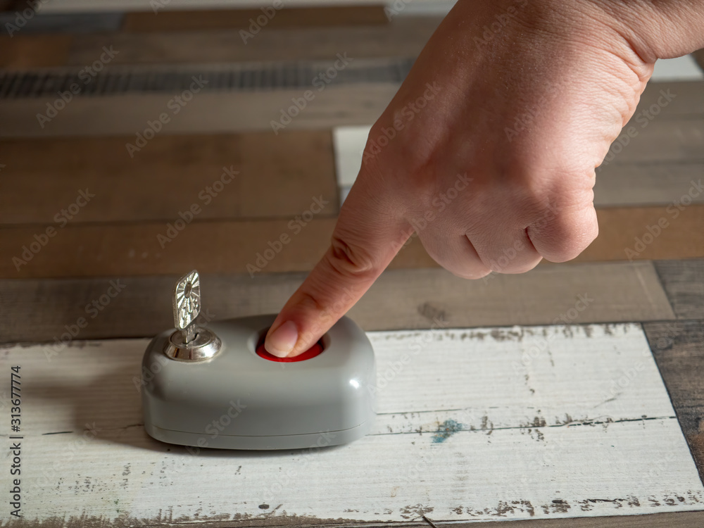 woman presses red alarm button. Close-up of a finger on a button. The ...