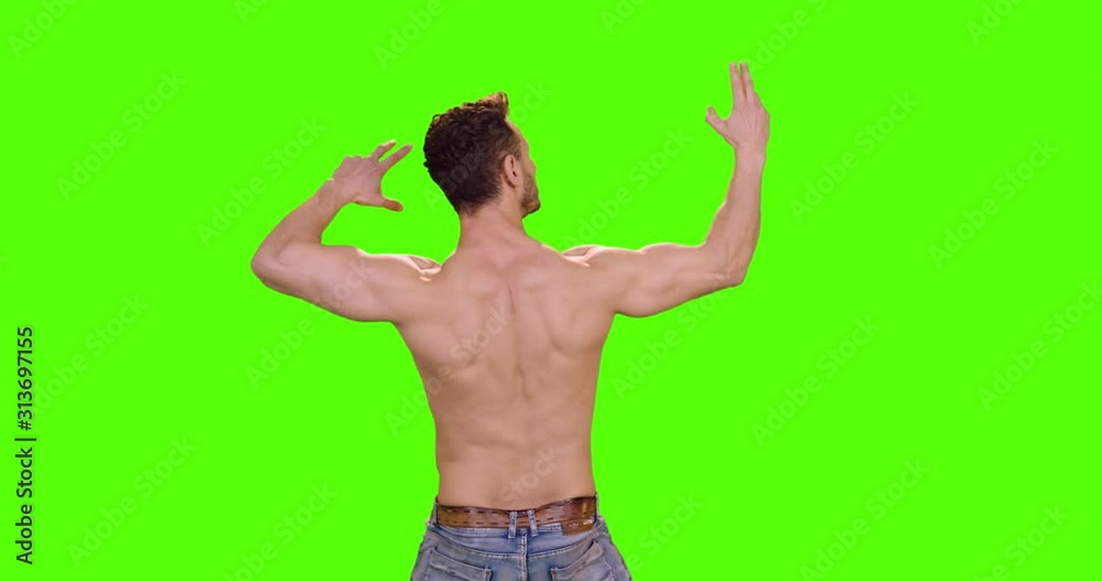 Vídeo do Stock: Handsome shirtless model shows his muscles from the ...