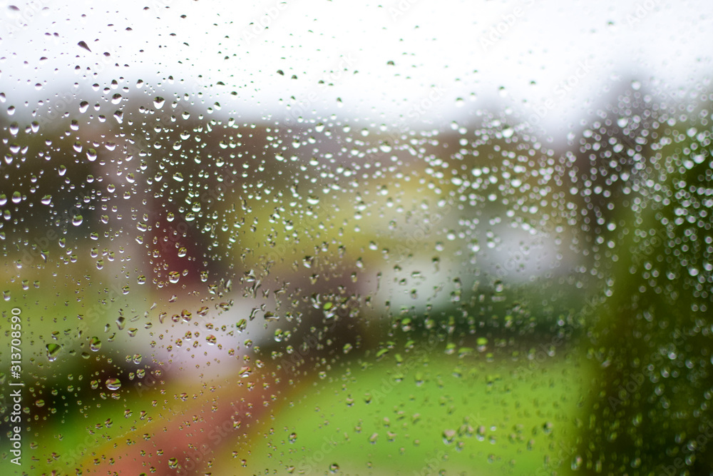 Raindrops on the window. The view from the window on the park during ...