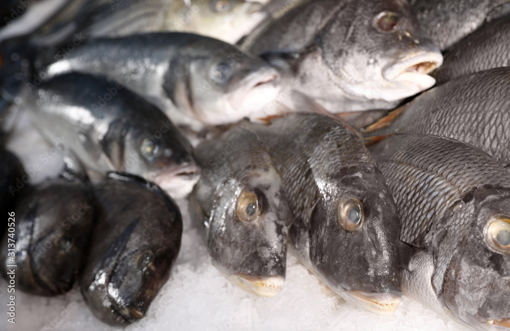 Different types of fresh fish on ice in supermarket, closeup Stock ...