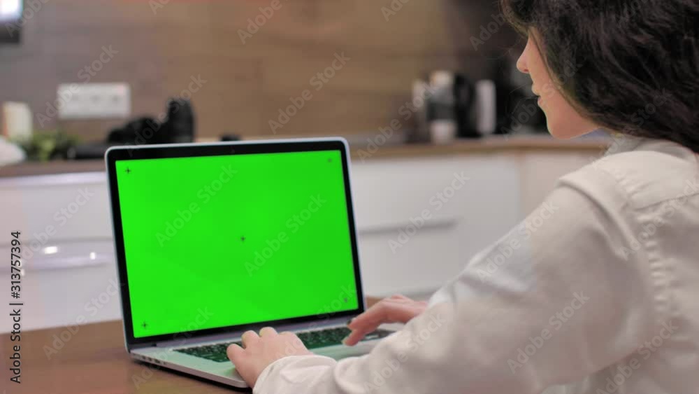 Woman using laptop computer with laptop green screen, 4K shot ...