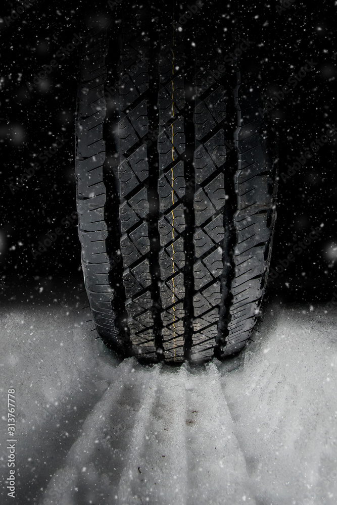 All terrain tire in snow. Snow track visible in snow with a rubber car ...
