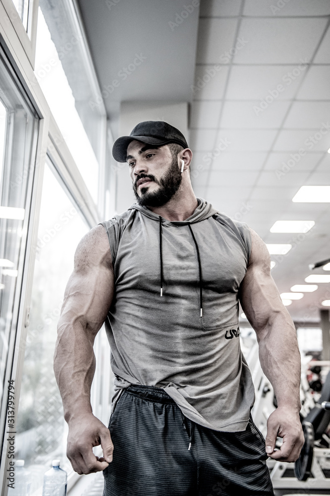 handsome young sport athlete caucasian man in cap and hoodie wearing ...