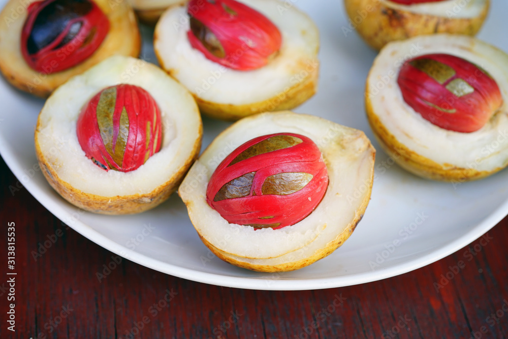 Fresh nutmeg (mace) seed pods in a red shell Stock Photo | Adobe Stock
