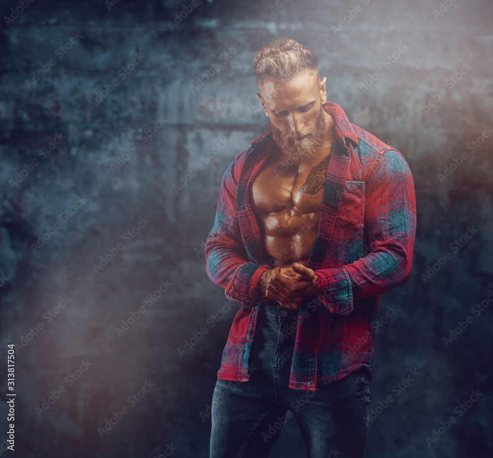 Handsome Athletic Male Fashion Model Posing In Shirt Exposing His