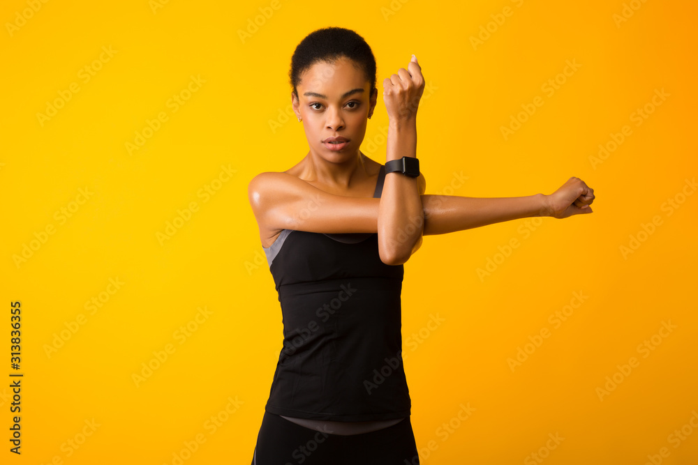 Afro Girl Doing Deltoid Arm Stretch Exercise Over Yellow Background ...