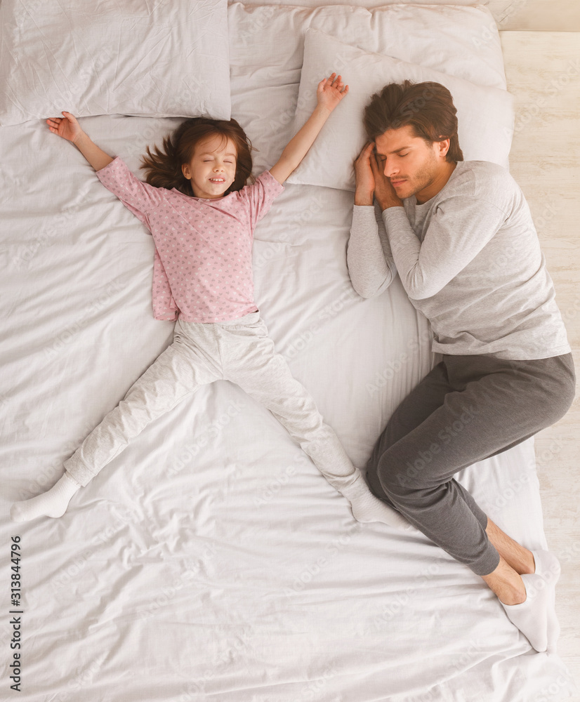 Dad and little girl sleeping together on bed Stock Photo | Adobe Stock
