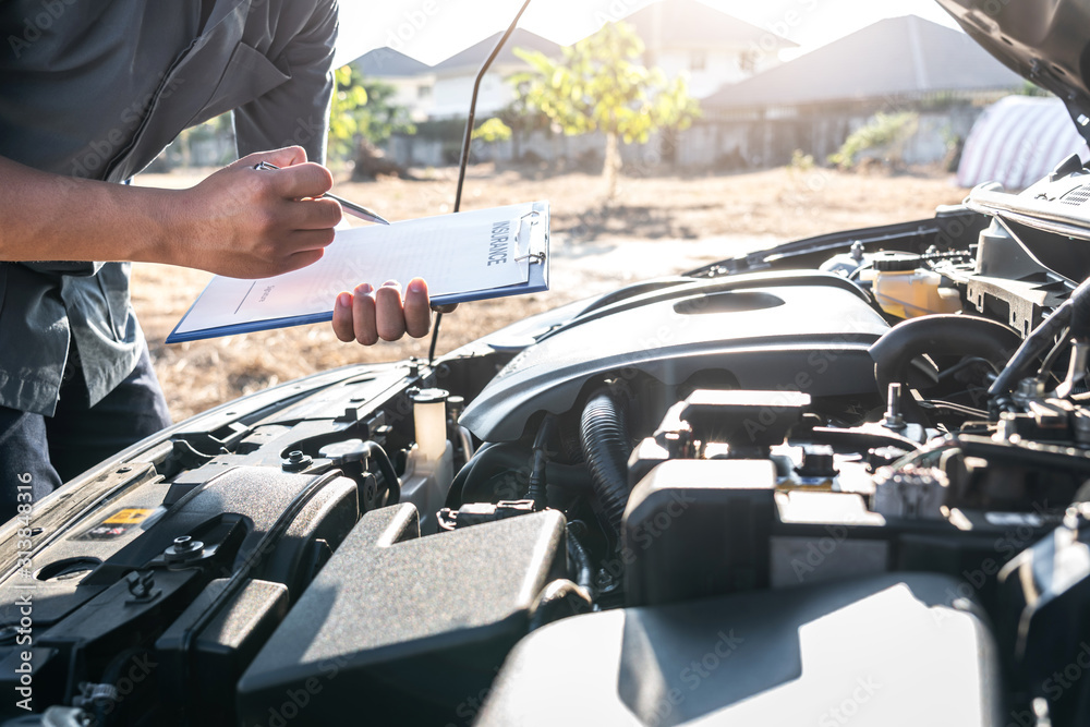 Technician engineer working of car mechanic in doing checklist for ...