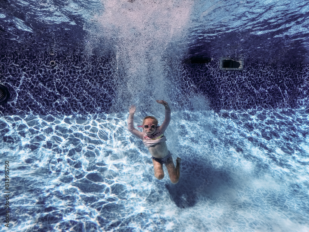 young girl underwater after jumping into pool water Stock Photo | Adobe ...