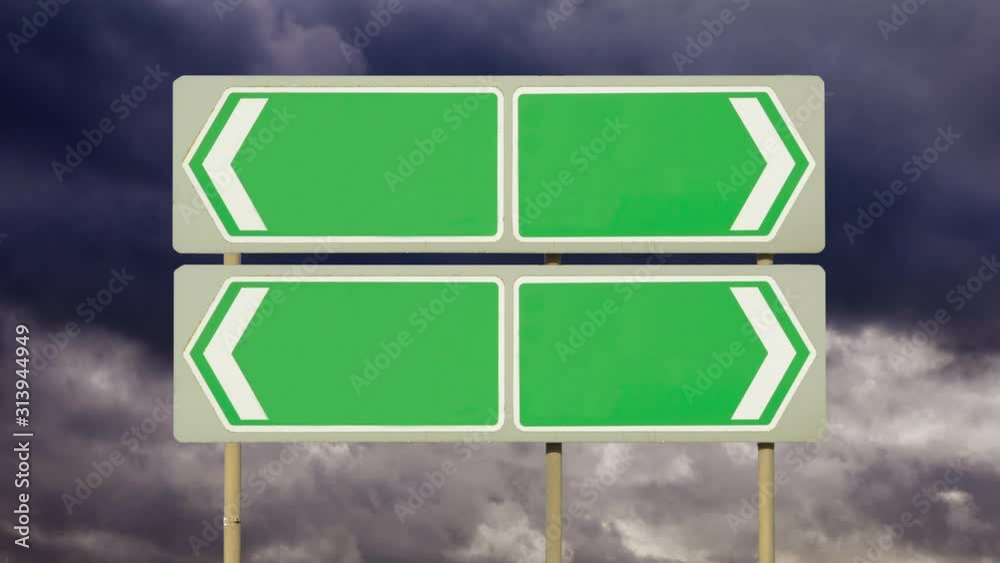 A blank road signs of a road dividing in opposite directions with a ...