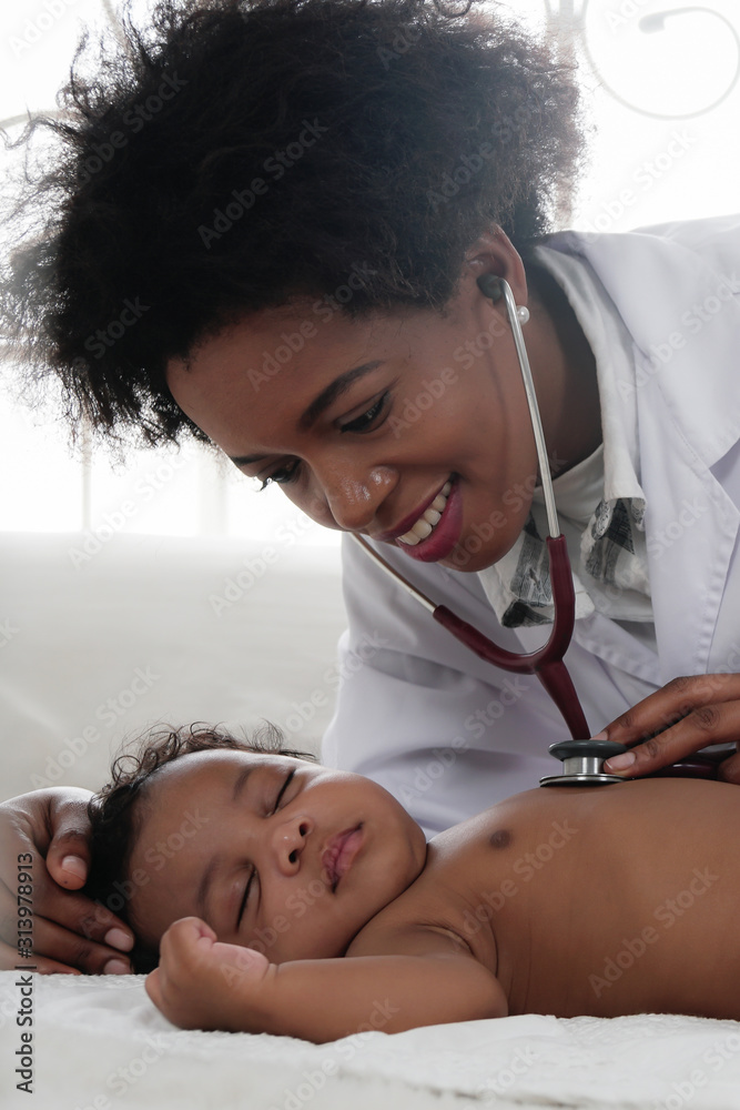 african american doctor checking up health of black baby girl with ...
