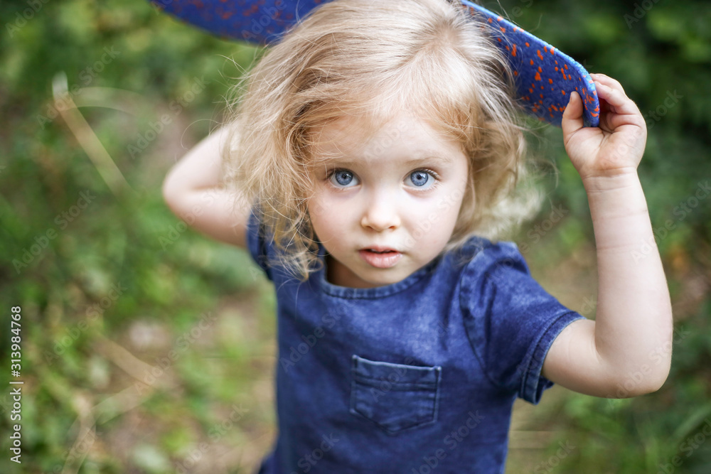 Little Girl With Curly Blonde Hair And Blue Eyes
