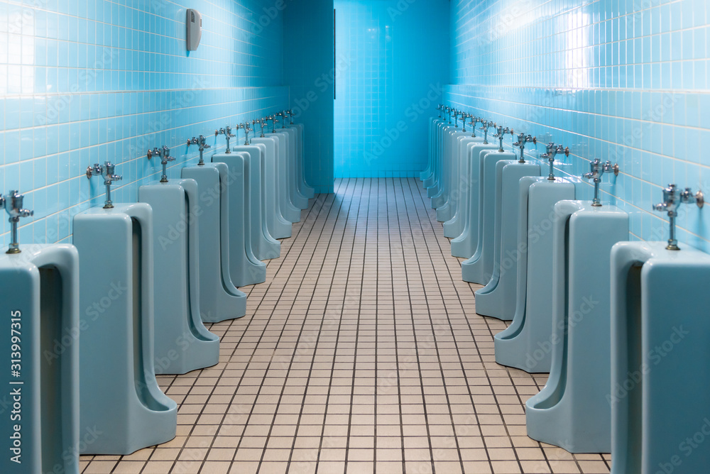 Men's room with white porcelain urinals in line. Comfort male toilet ...