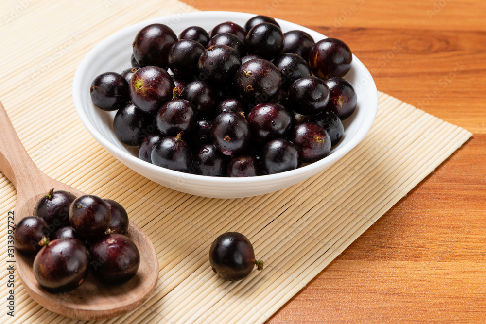 Jabuticaba in the wooden spoon and bowl. Jaboticaba or Jabuticaba is ...