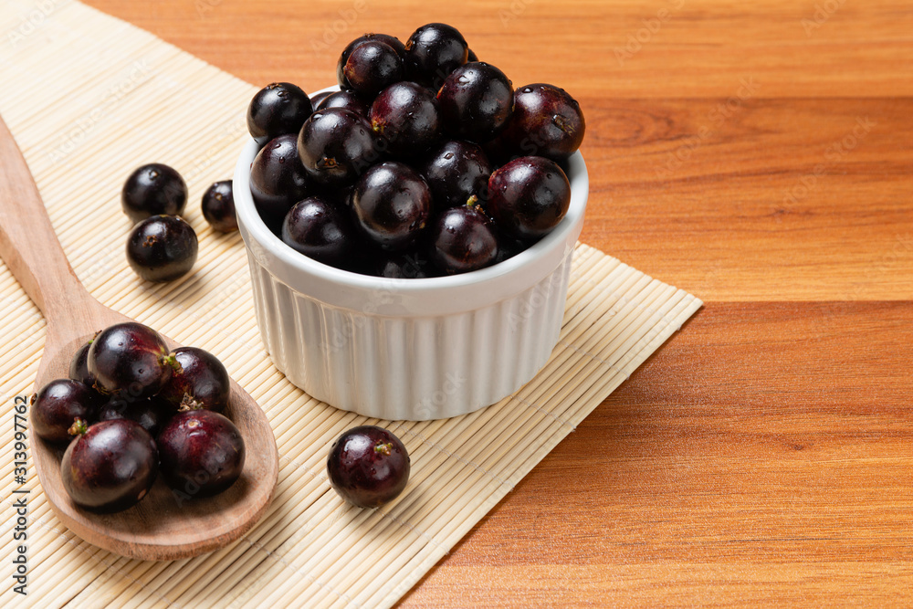 Jabuticaba in the wooden spoon and bowl. Jaboticaba or Jabuticaba is ...